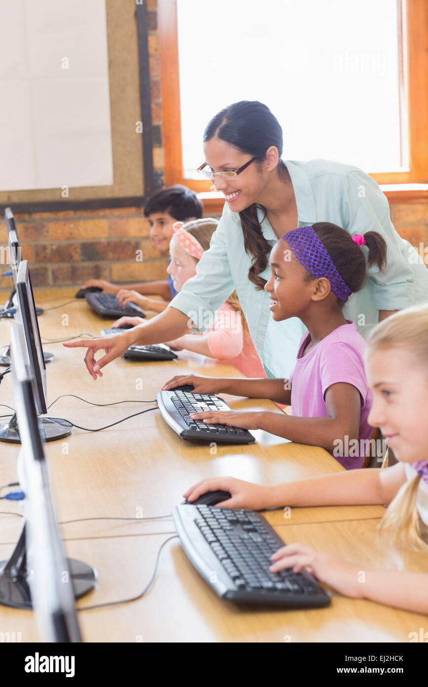 Cute pupils in computer class with teacher Stock Photo - Alamy