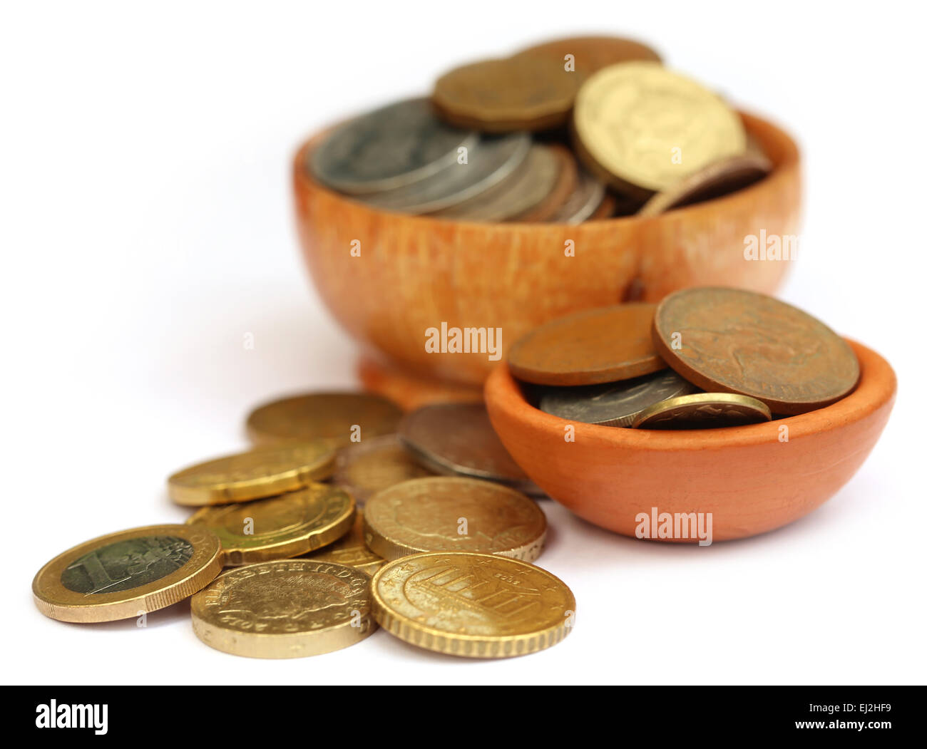Old coins arranged in bowls over white background Stock Photo - Alamy