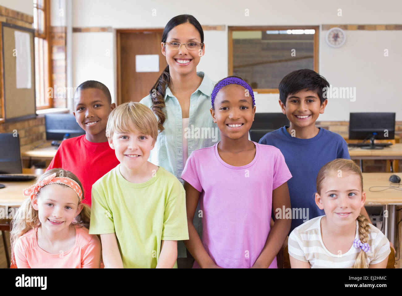 Cute pupils in computer class with teacher Stock Photo - Alamy
