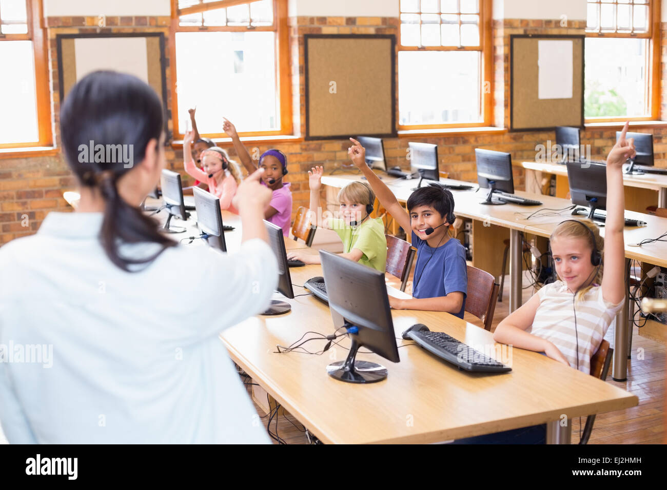 Boy raising hand computer class hi-res stock photography and images - Alamy