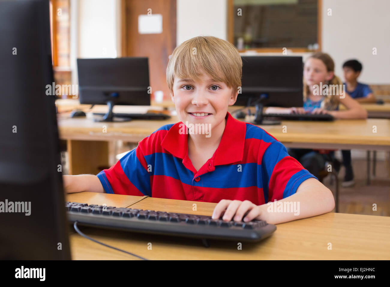 Cute pupil in computer class Stock Photo - Alamy