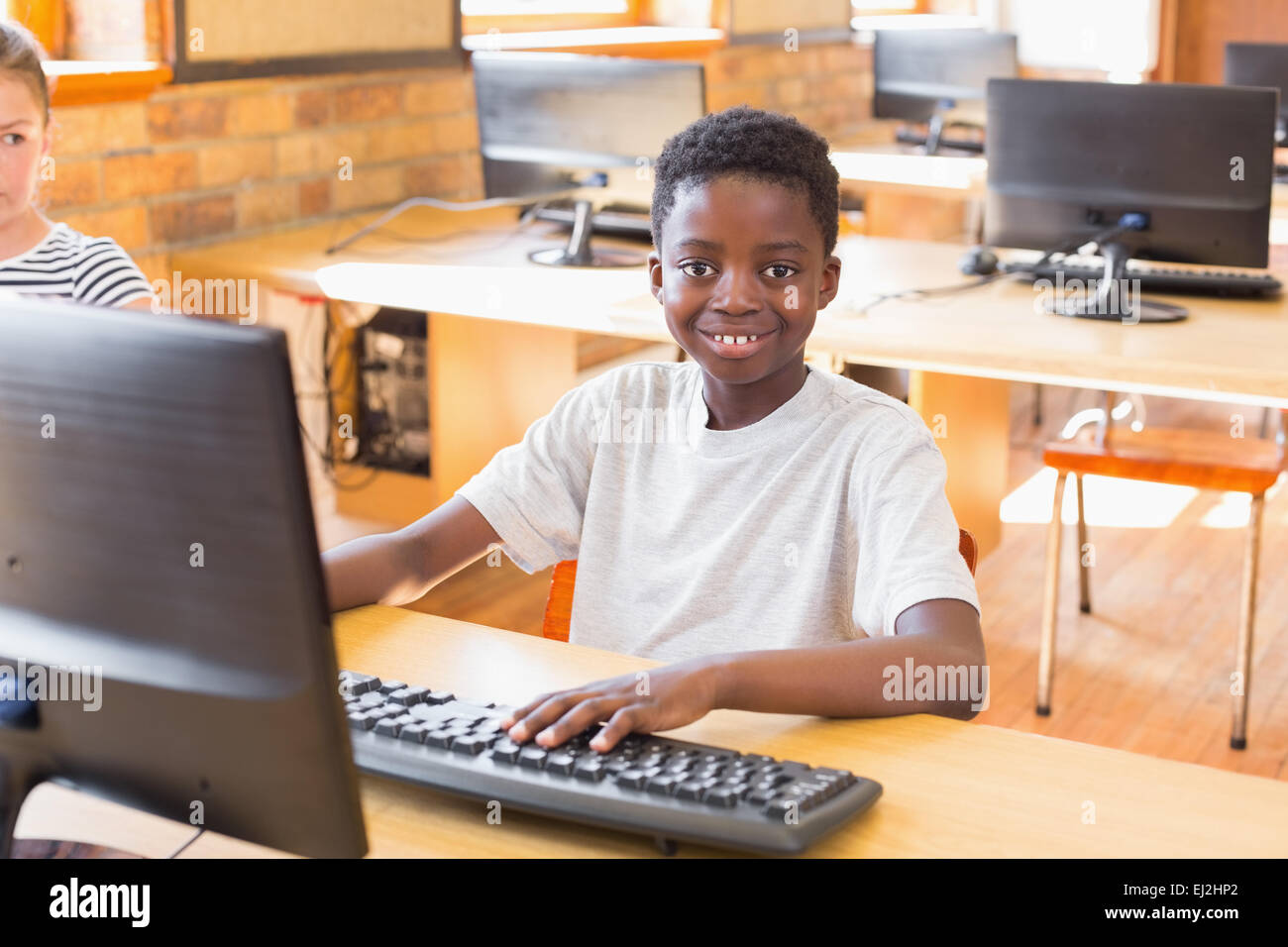 Cute pupil in computer class Stock Photo - Alamy