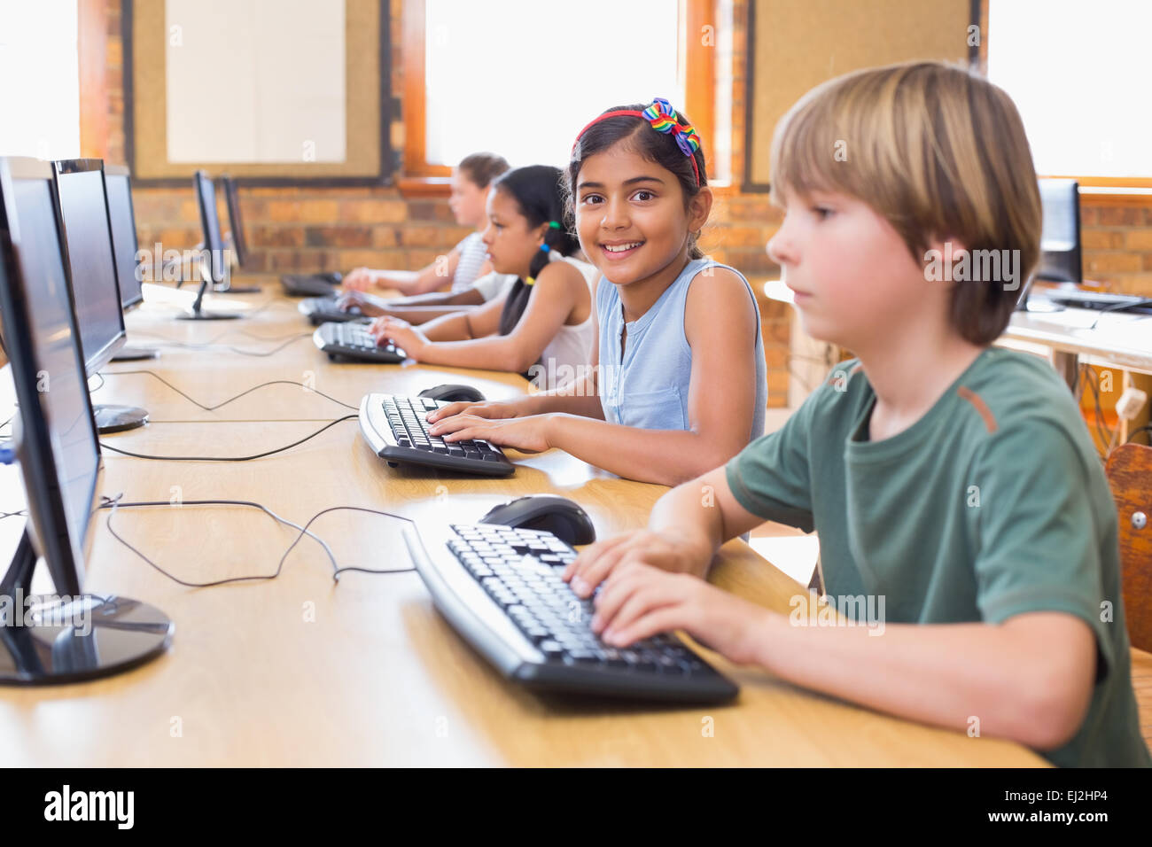 Cute pupils in computer class Stock Photo - Alamy