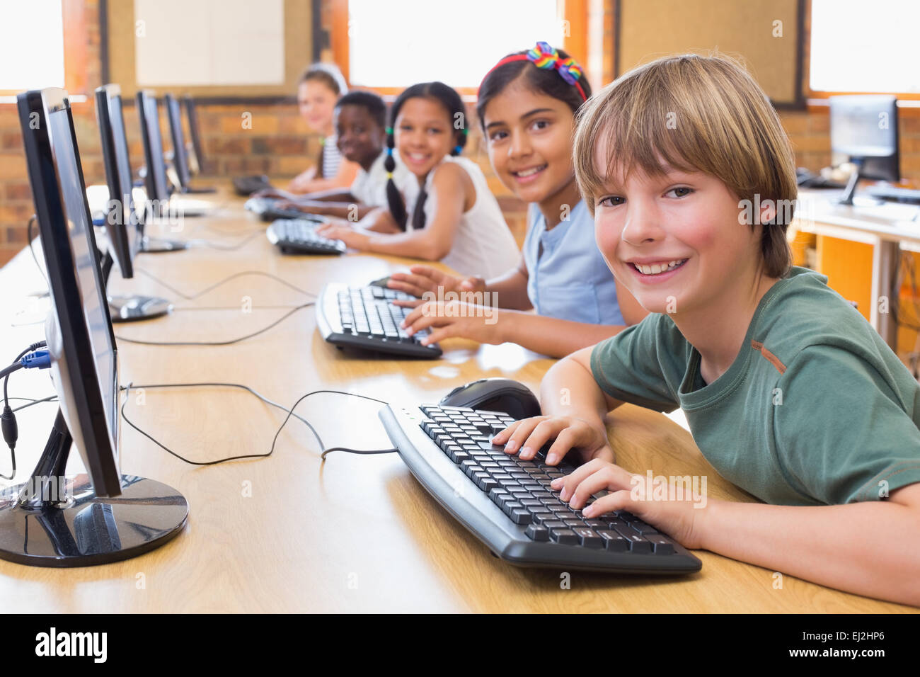 Cute pupils in computer class Stock Photo - Alamy