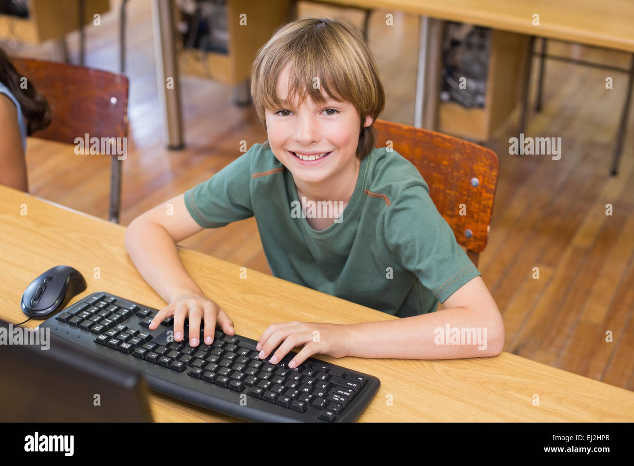 Cute pupil in computer class Stock Photo - Alamy