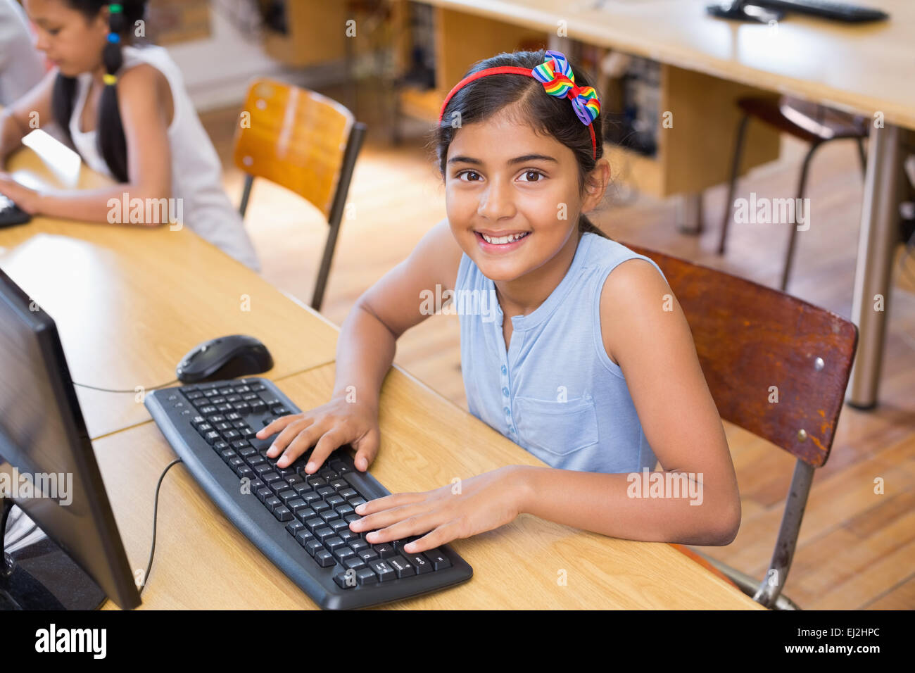 Cute pupil in computer class Stock Photo - Alamy