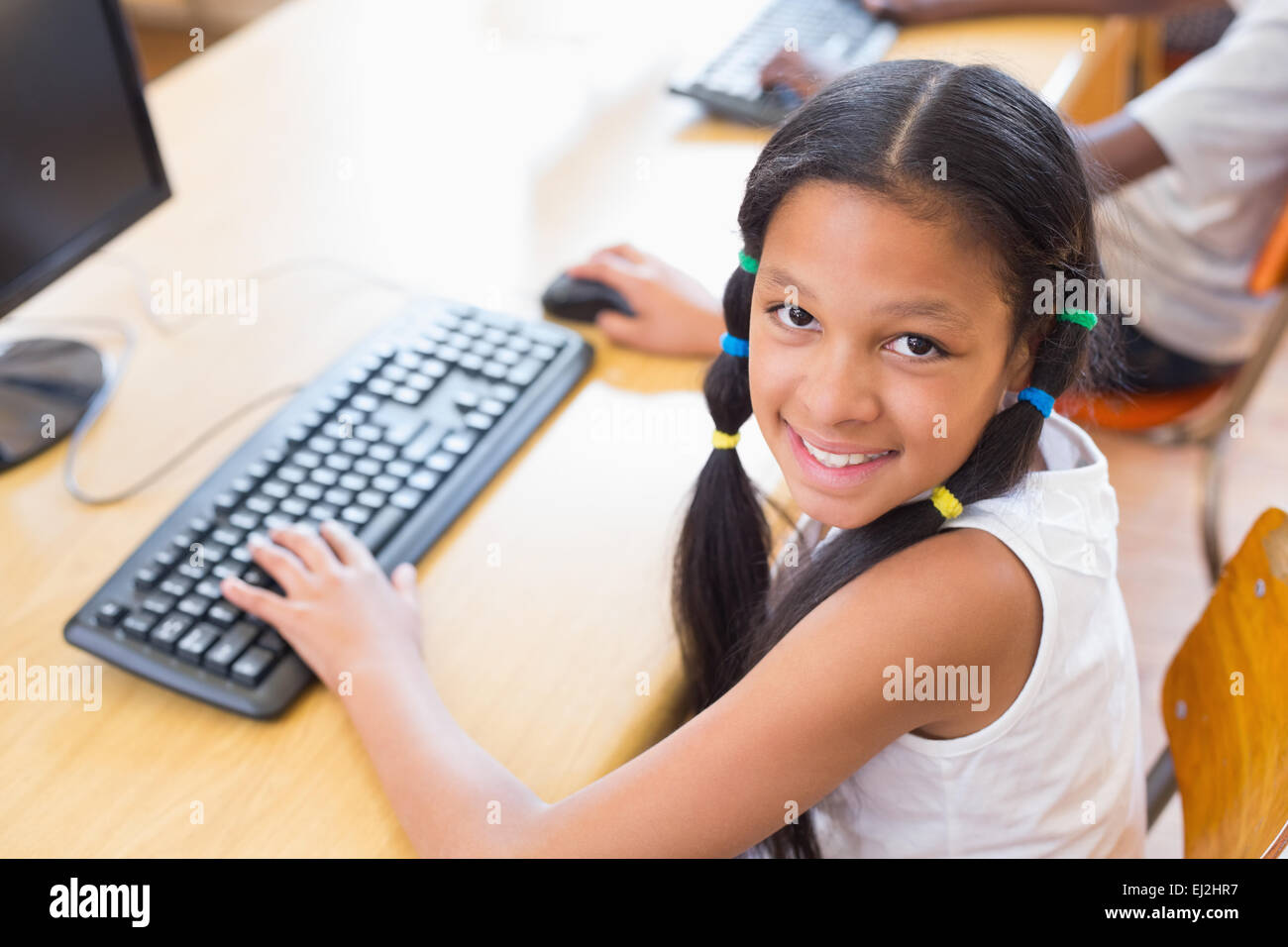 Cute pupil in computer class Stock Photo - Alamy