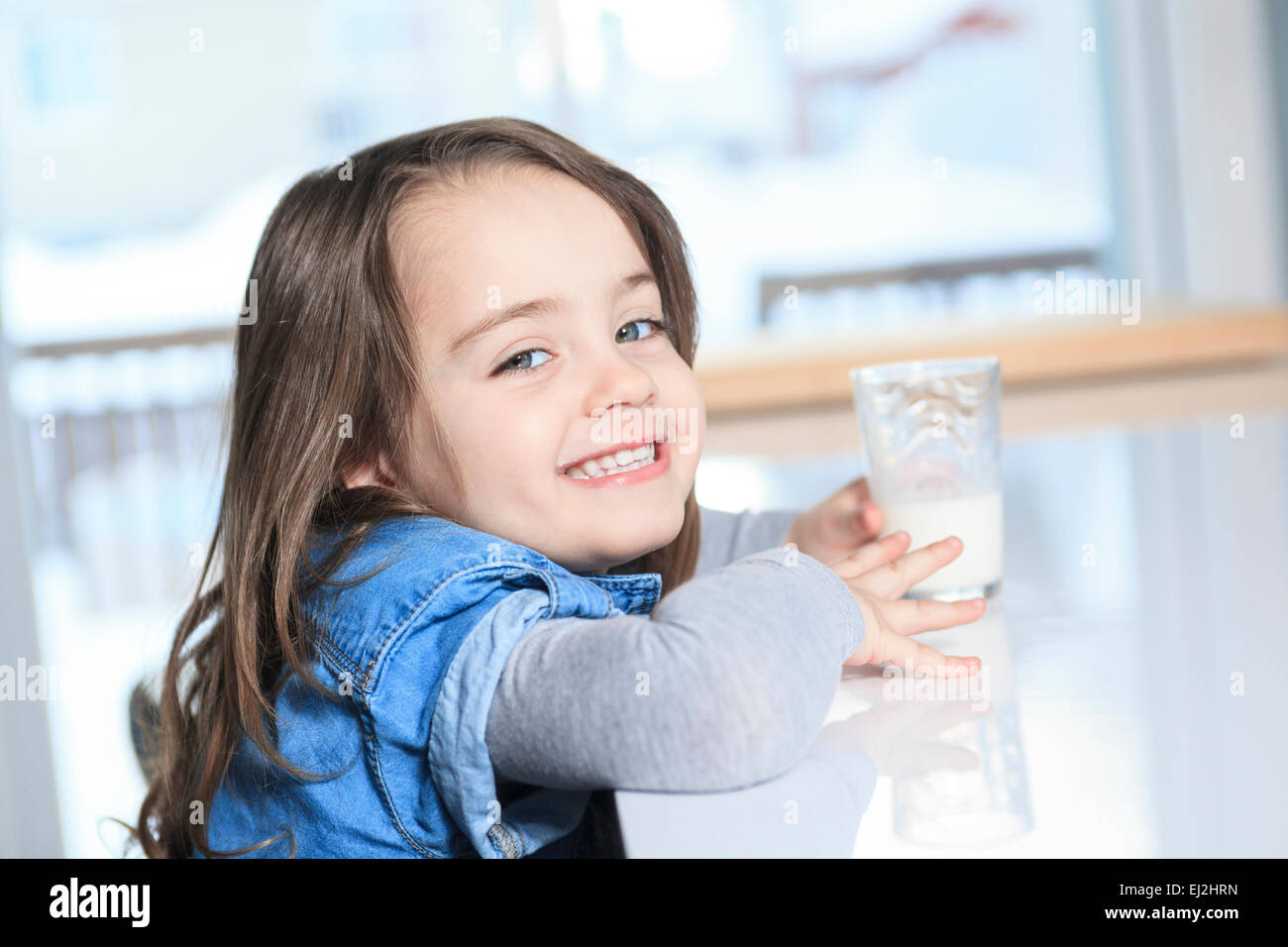 A Happy little child drinking milk on a kitchen Stock Photo - Alamy