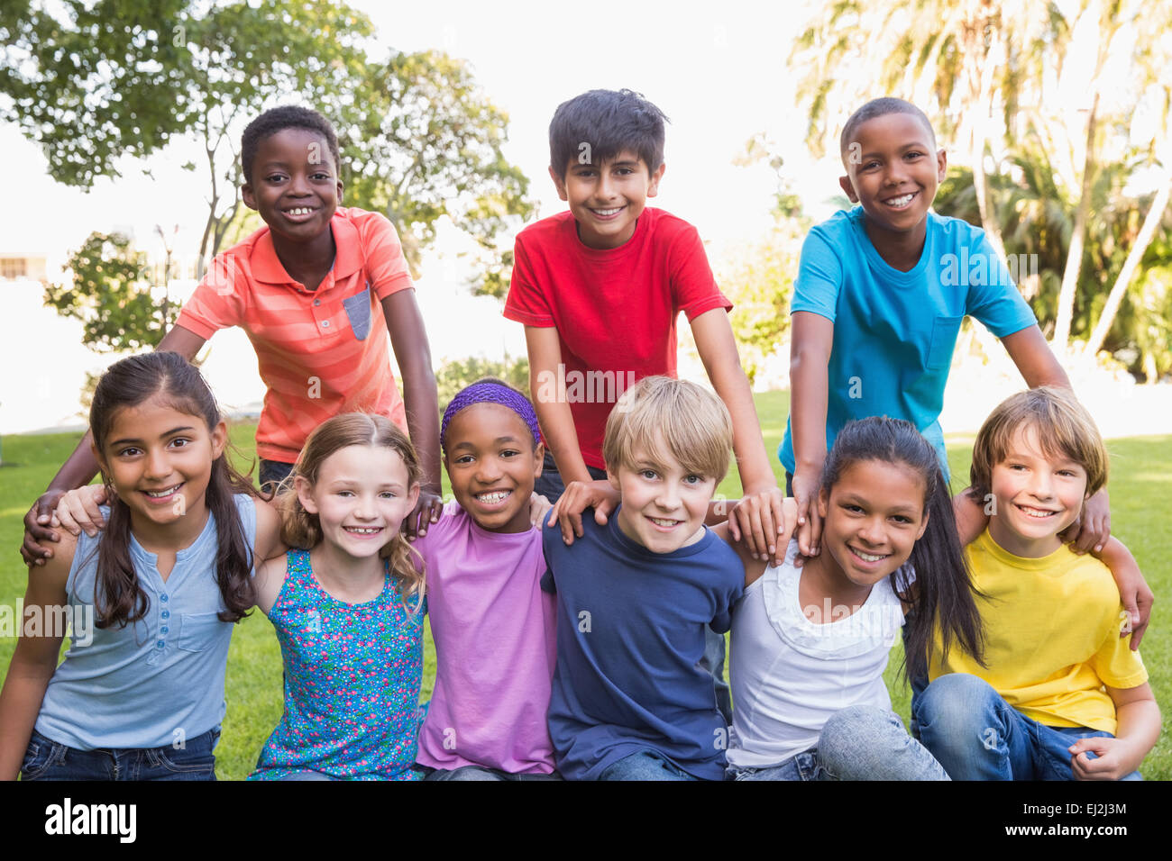 Happy friends in the park Stock Photo - Alamy