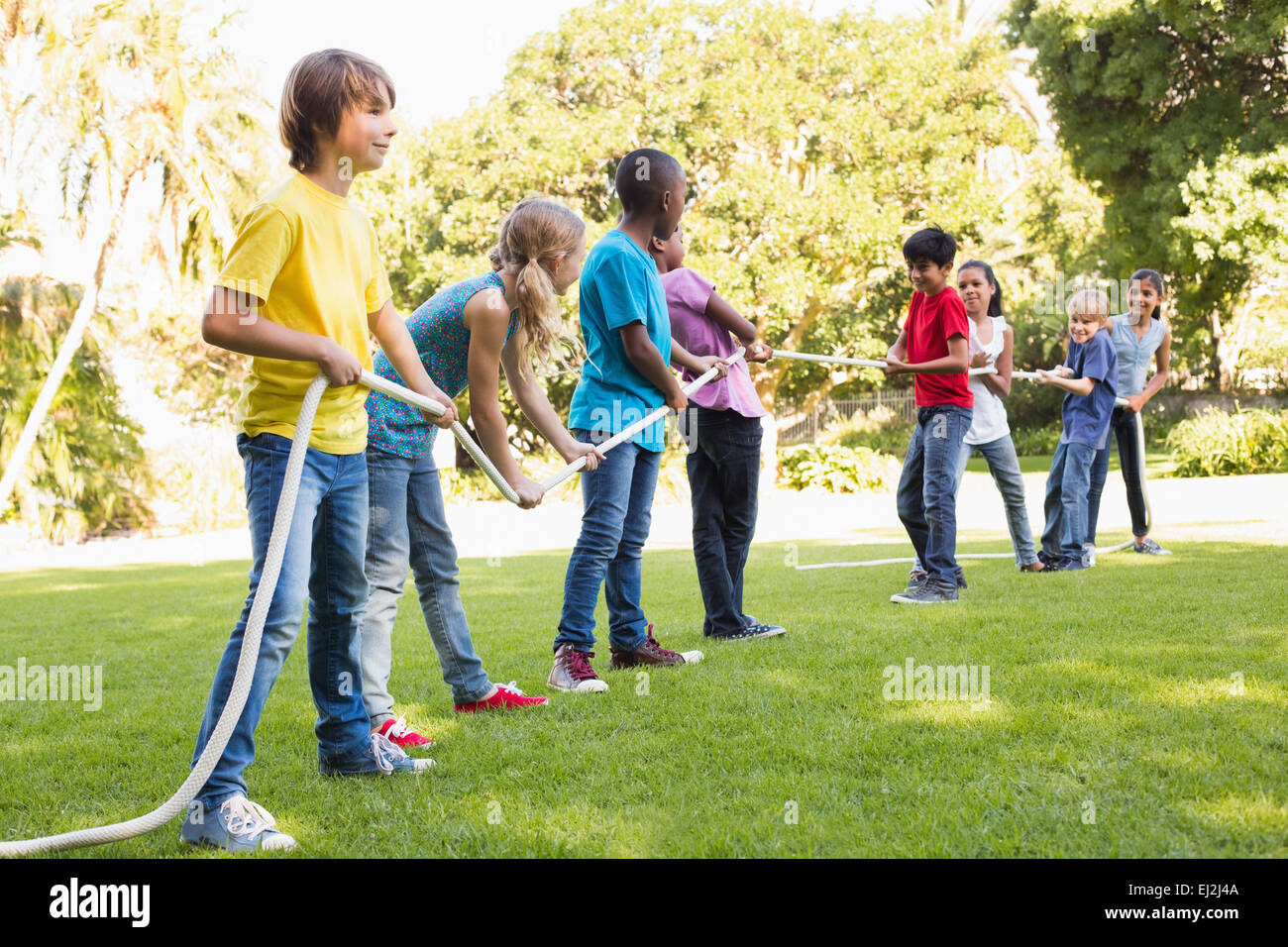 Happy friends playing in the park Stock Photo - Alamy
