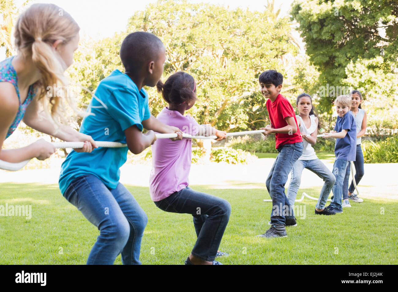 Happy friends playing in the park Stock Photo - Alamy