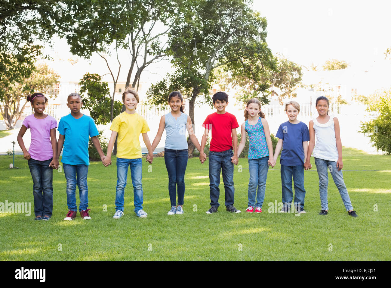 Happy friends playing in the park Stock Photo - Alamy
