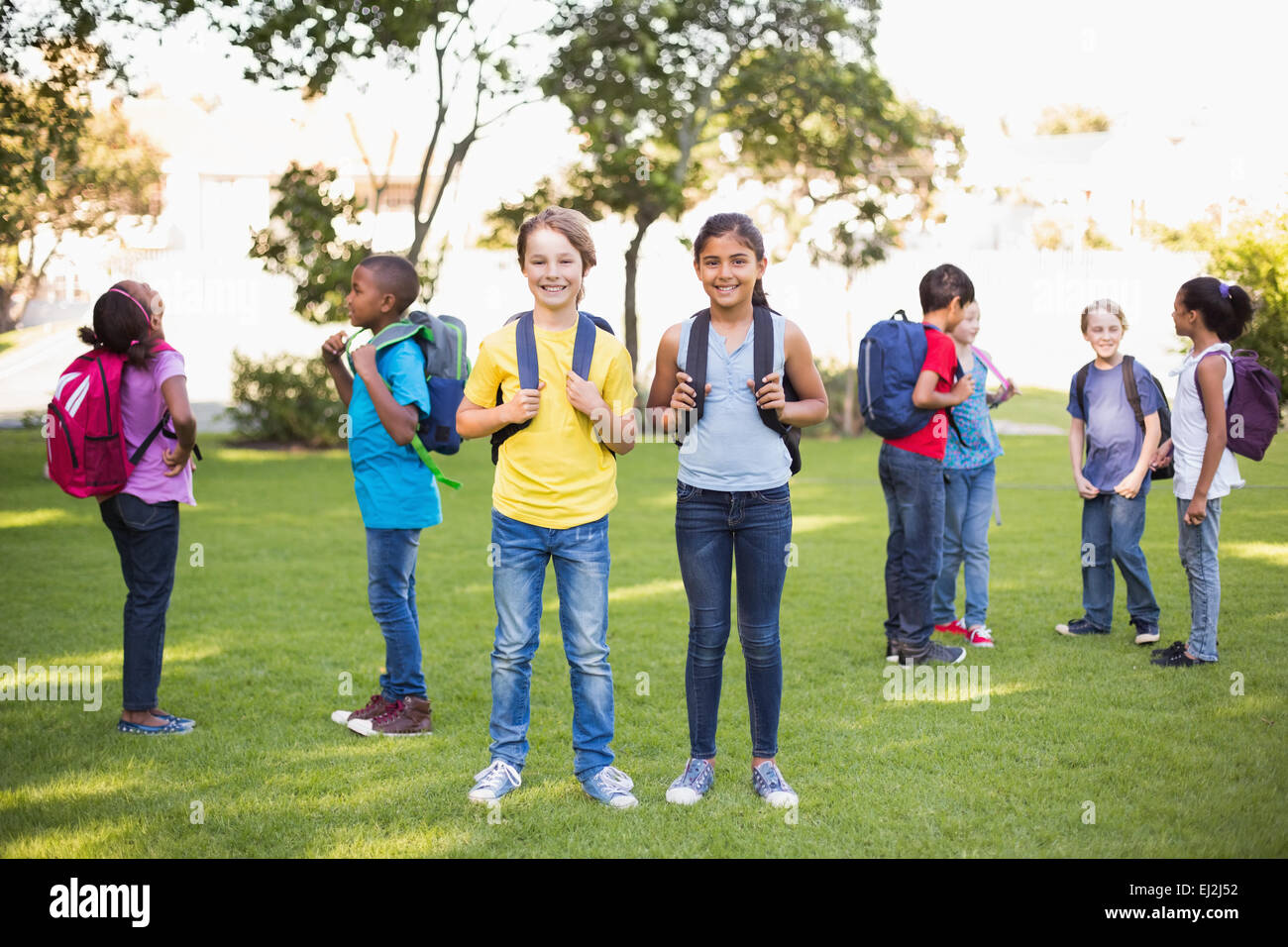 Happy friends playing in the park Stock Photo - Alamy