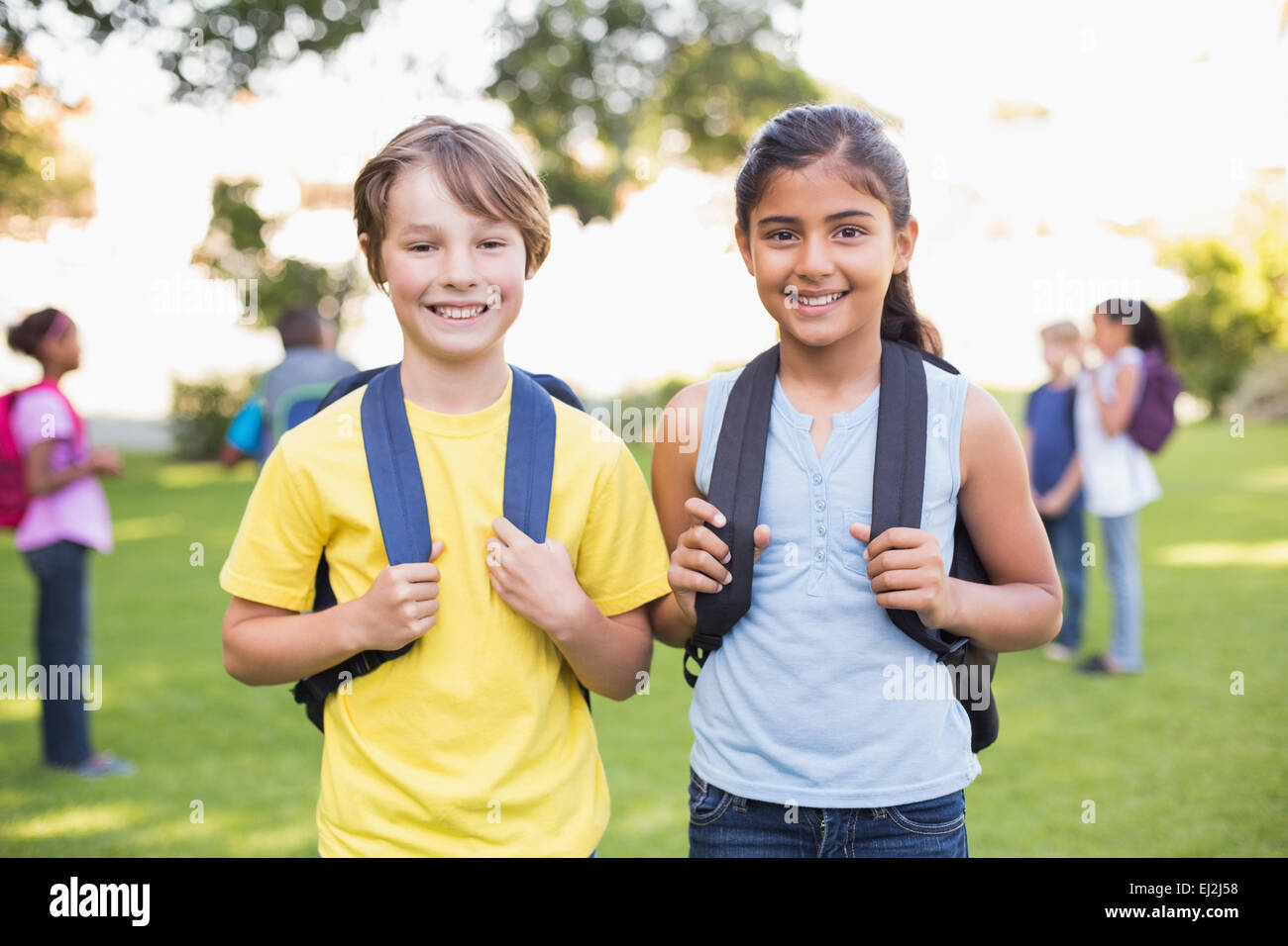 Happy friends playing in the park Stock Photo - Alamy