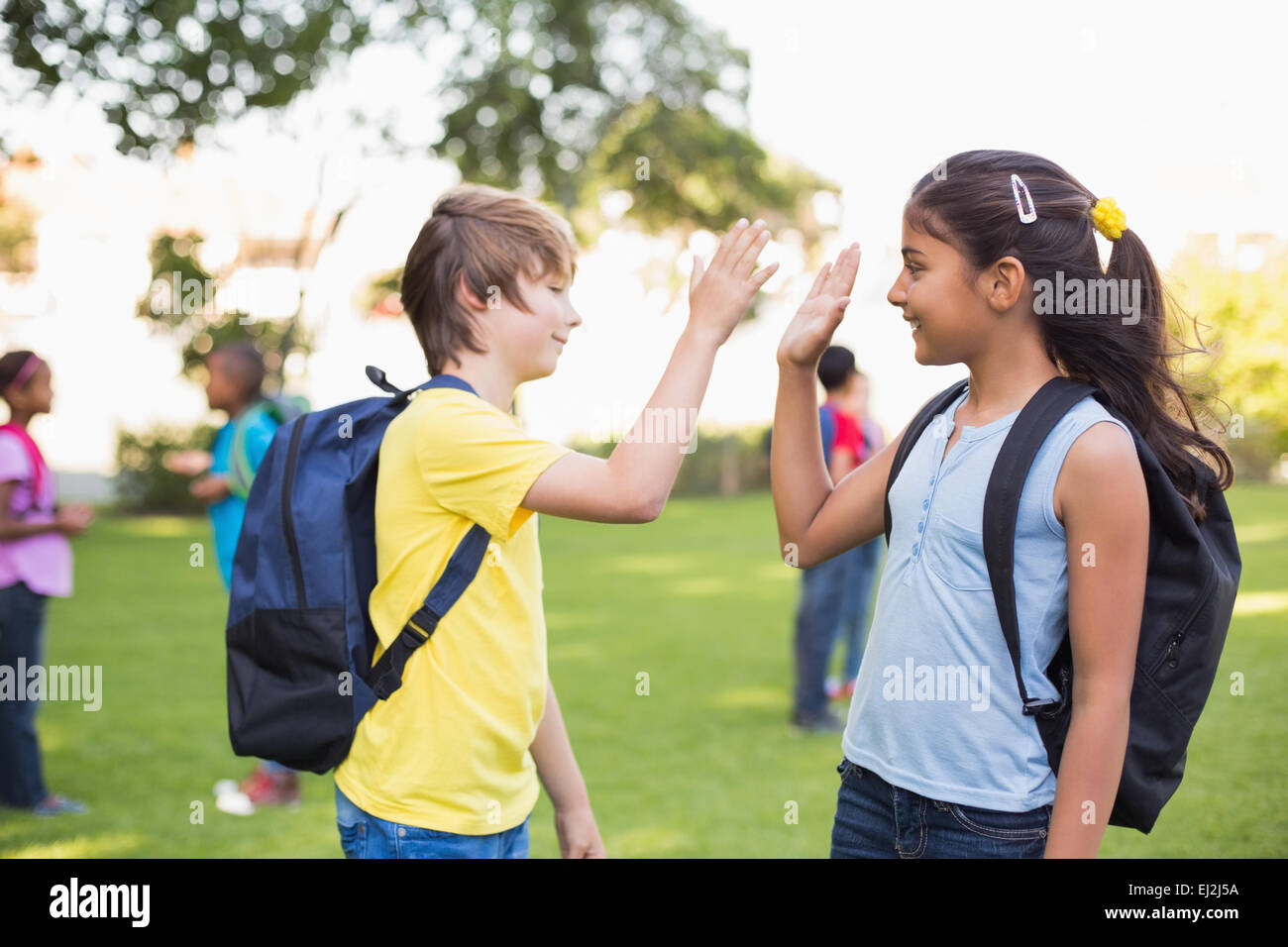 Happy friends playing in the park Stock Photo - Alamy