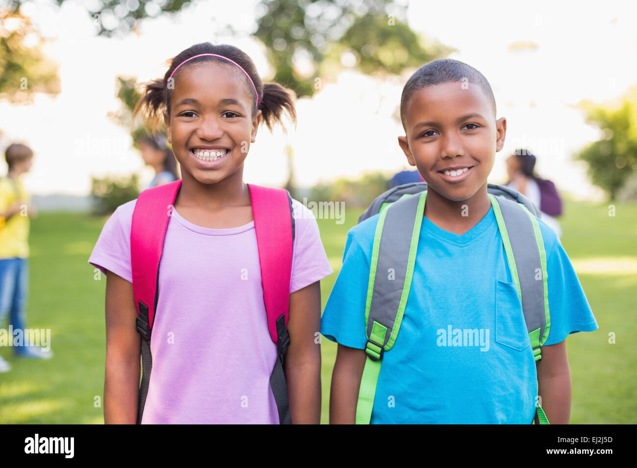 Happy friends playing in the park Stock Photo - Alamy