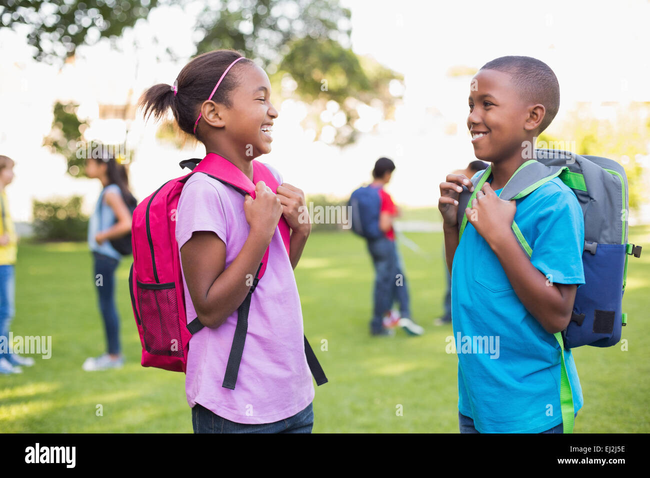 Happy friends playing in the park Stock Photo - Alamy
