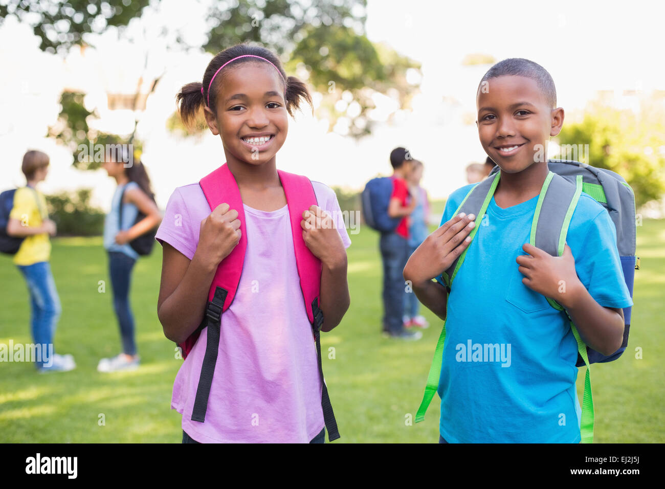 Happy friends playing in the park Stock Photo - Alamy