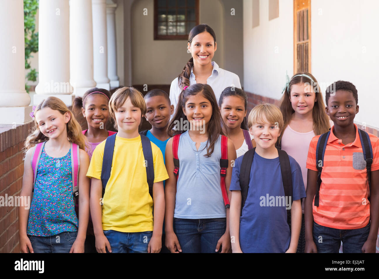 Cute pupils smiling at camera in the hall Stock Photo - Alamy