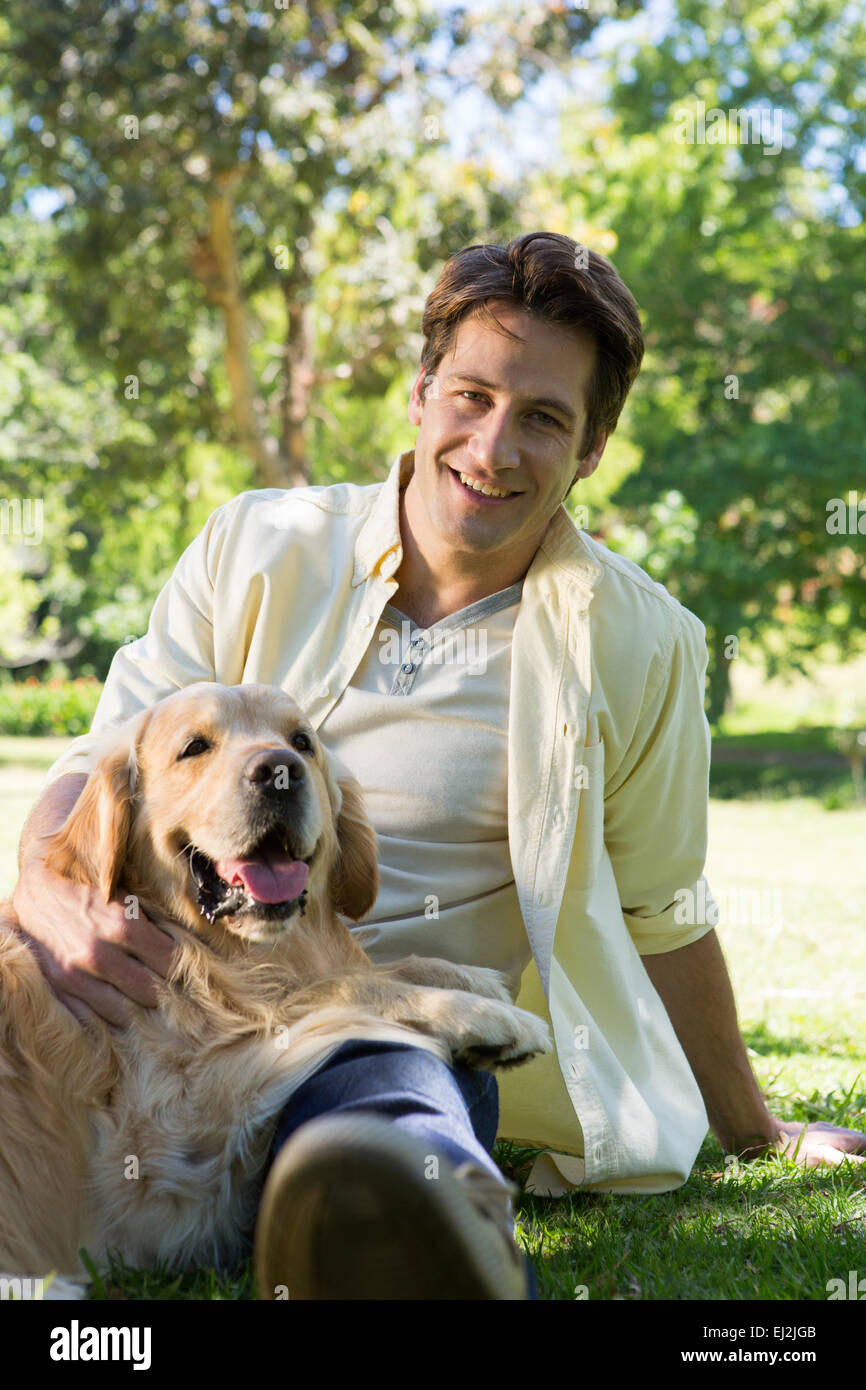 Happy man with his pet dog in park Stock Photo - Alamy