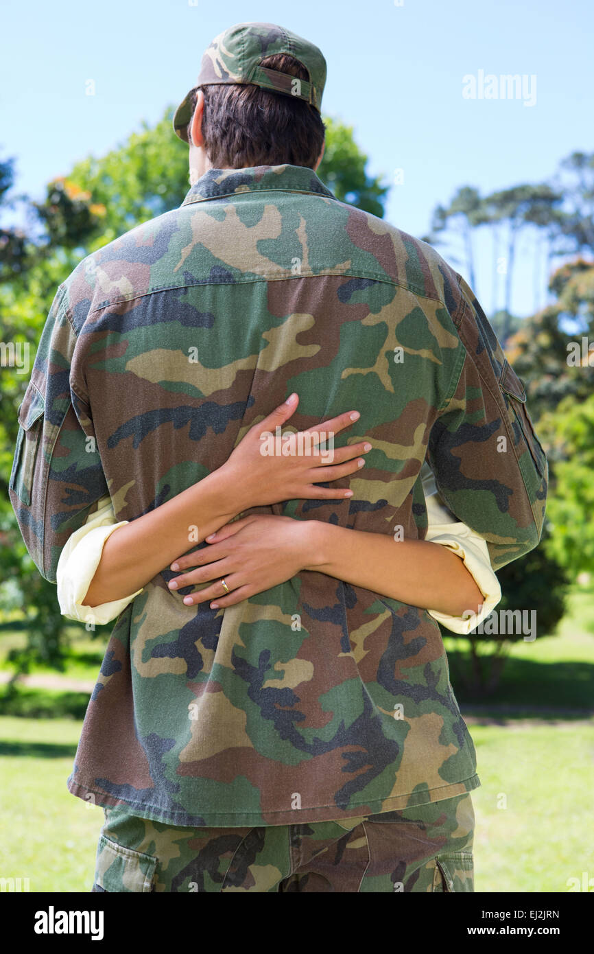 Handsome soldier reunited with partner Stock Photo - Alamy