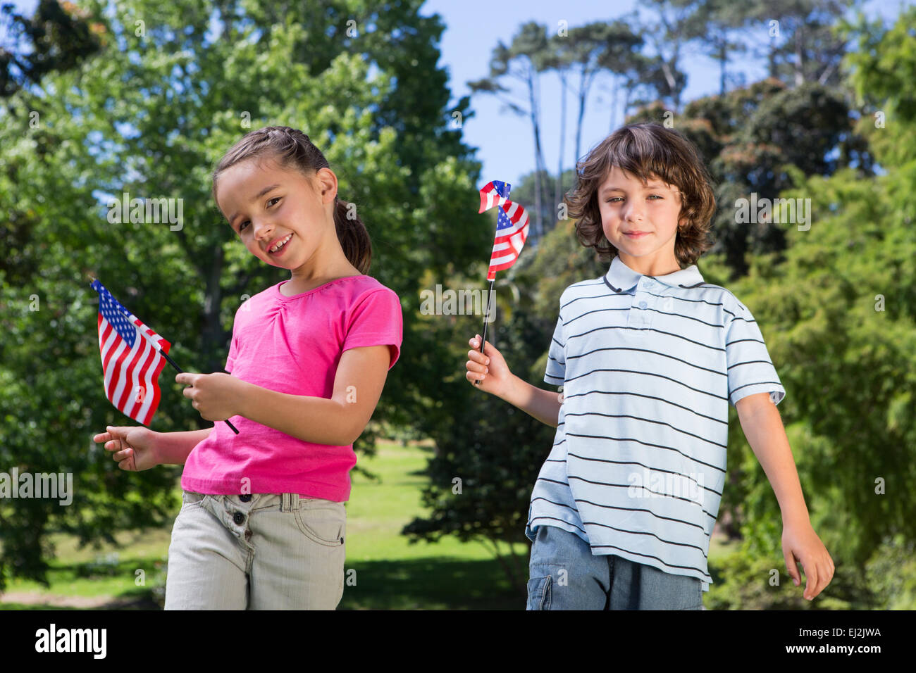 Little siblings waving american flag Stock Photo - Alamy