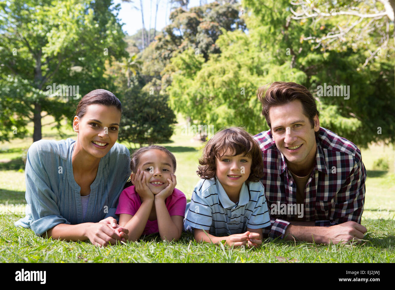 Happy family smiling at camera Stock Photo - Alamy