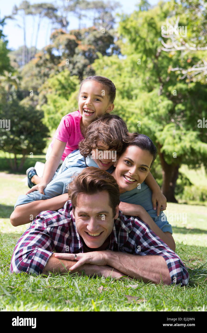 Happy family smiling at camera Stock Photo - Alamy