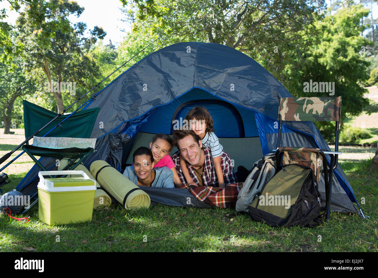 Happy family on a camping trip in their tent Stock Photo - Alamy