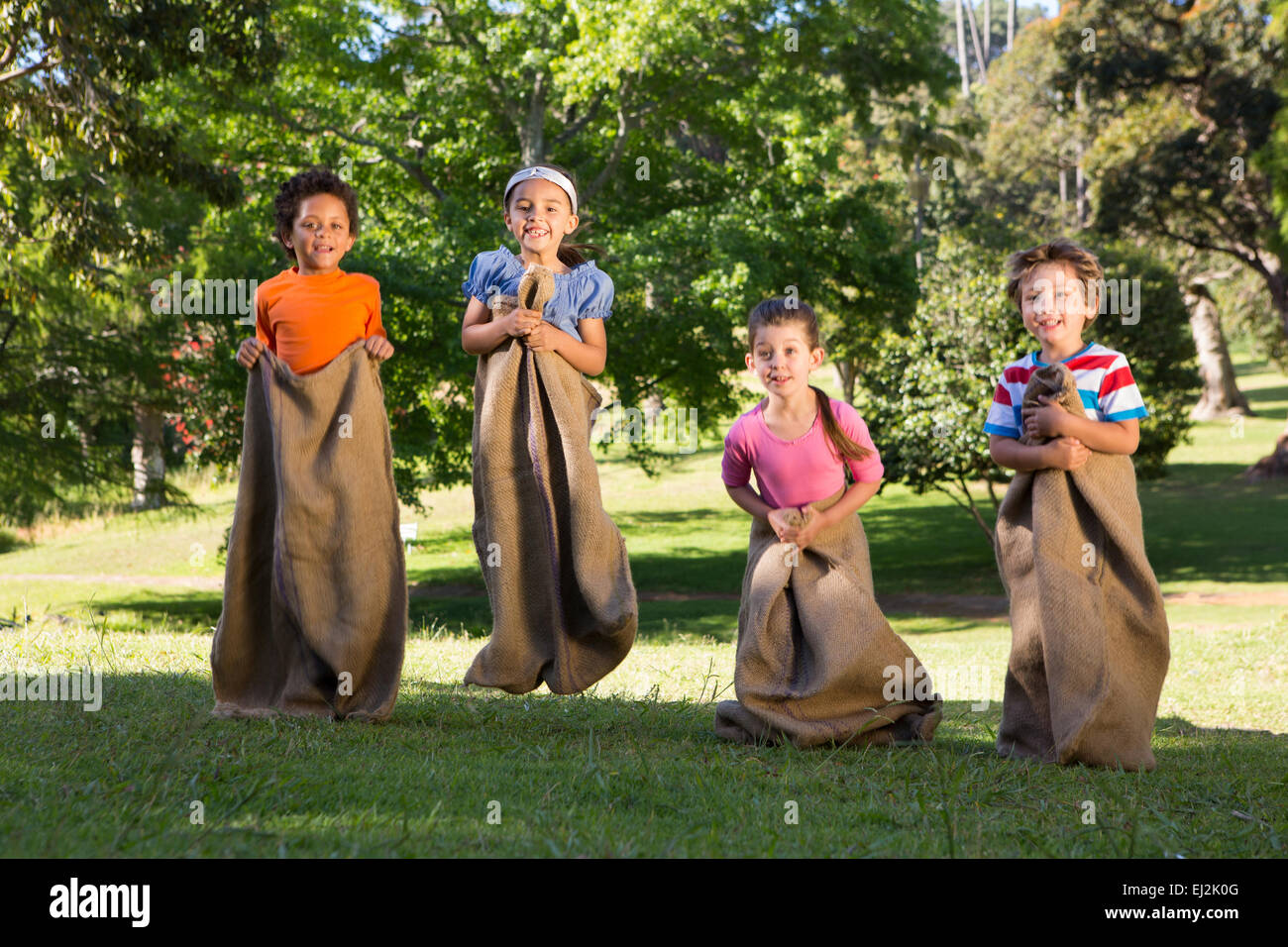 Children having a sack race in park Stock Photo - Alamy