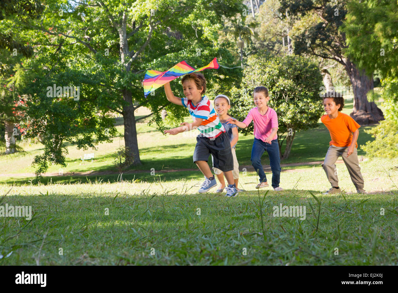 Children playing with kite in park Stock Photo - Alamy