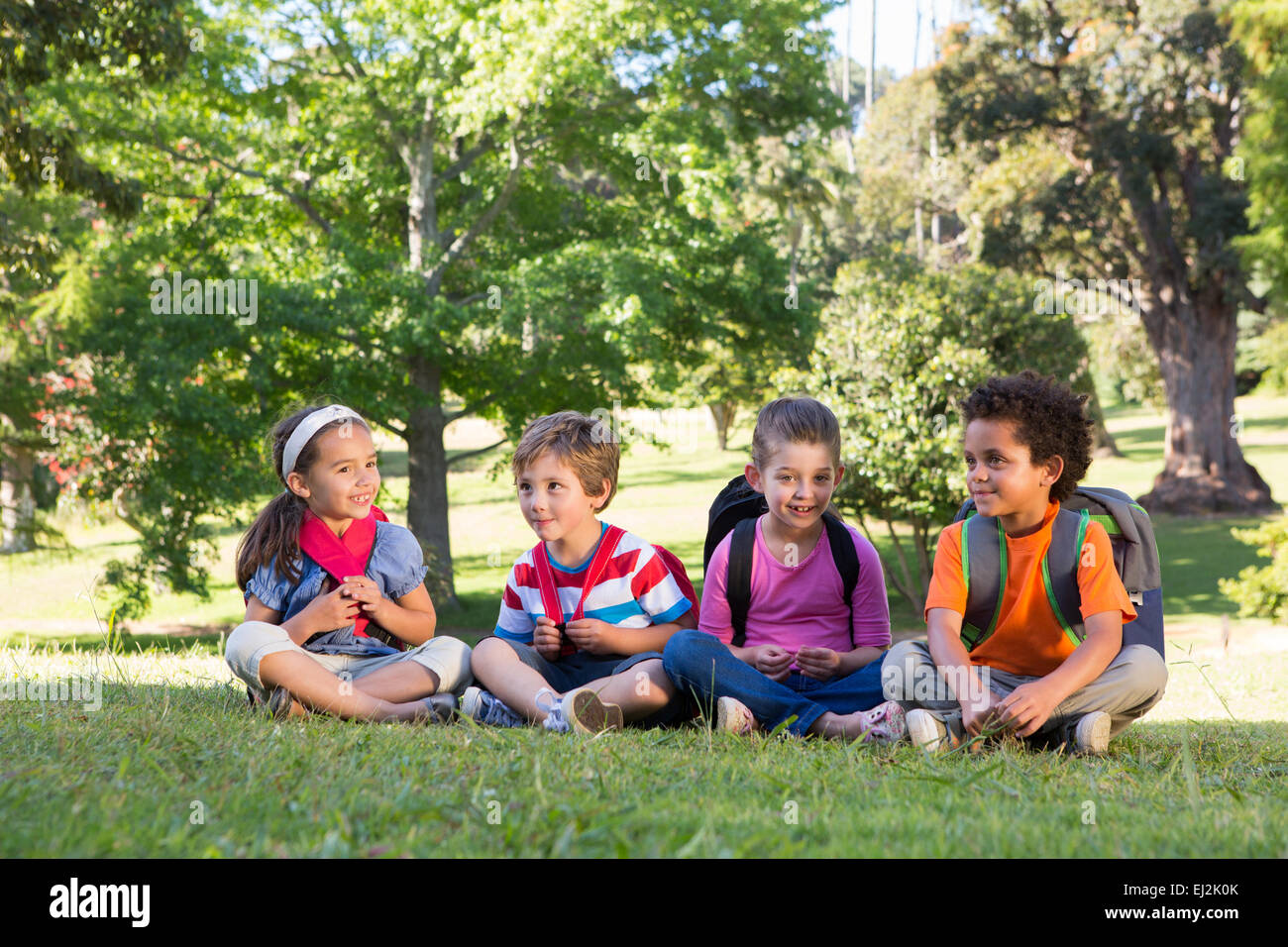 School children sitting on grass Stock Photo - Alamy