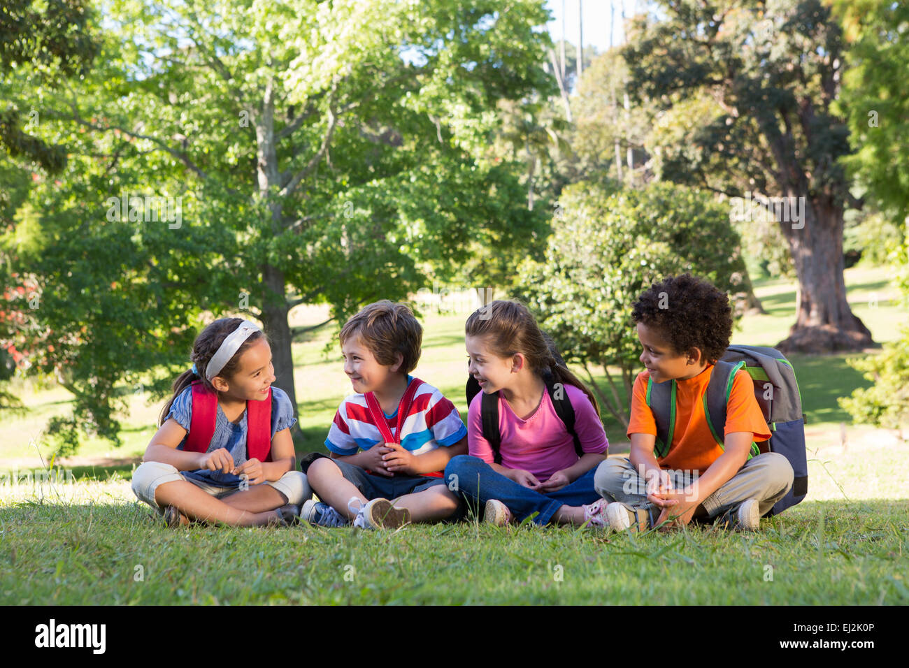 School children sitting on grass Stock Photo - Alamy