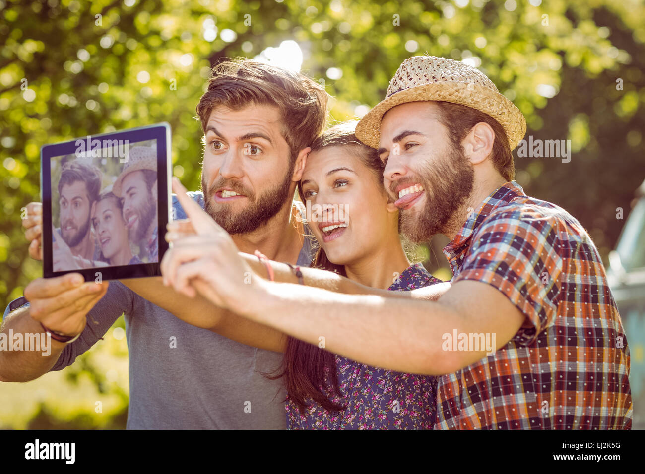 Friends taking funny selfie together outdoors hi-res stock photography ...