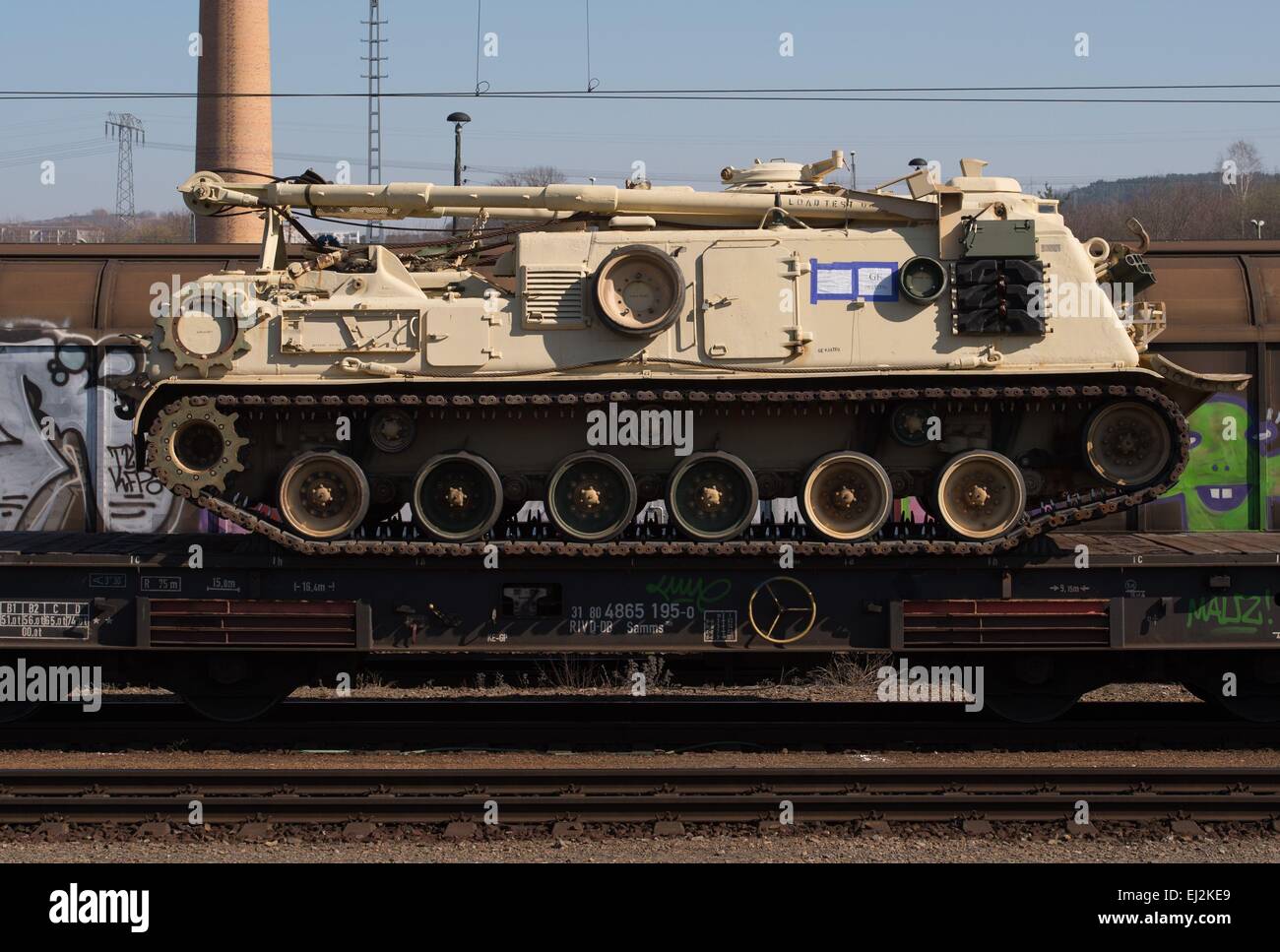 A tank of the US Army stands loaded on a freight train on the train ...