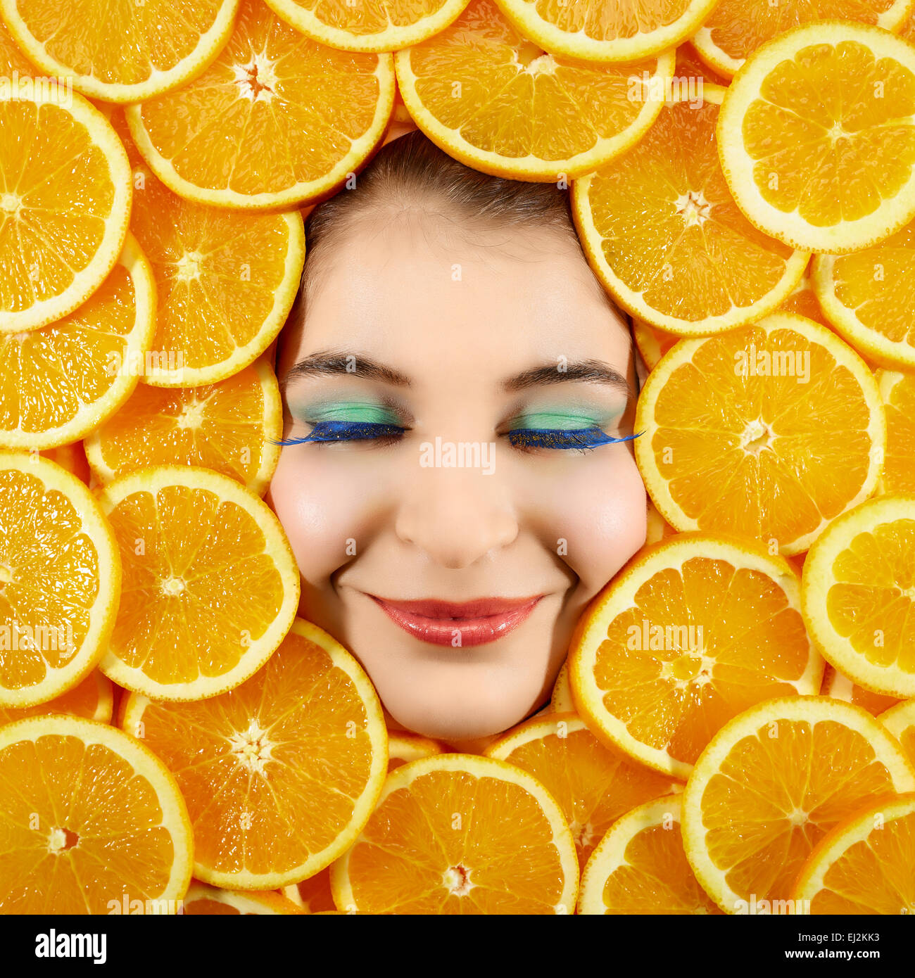 Beautiful woman expression face with orange slice frame Stock Photo - Alamy