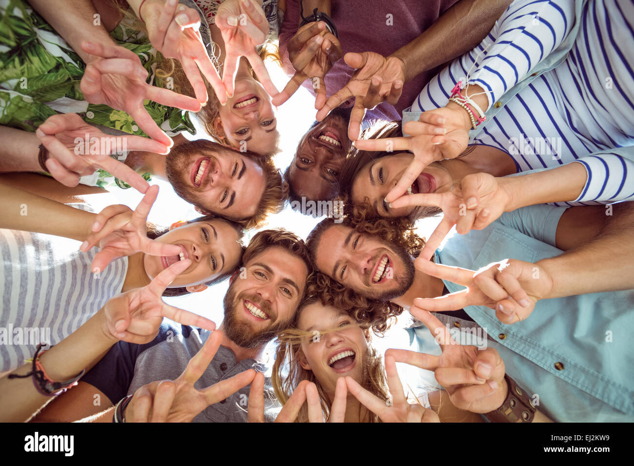 Happy young friends putting hands together Stock Photo - Alamy