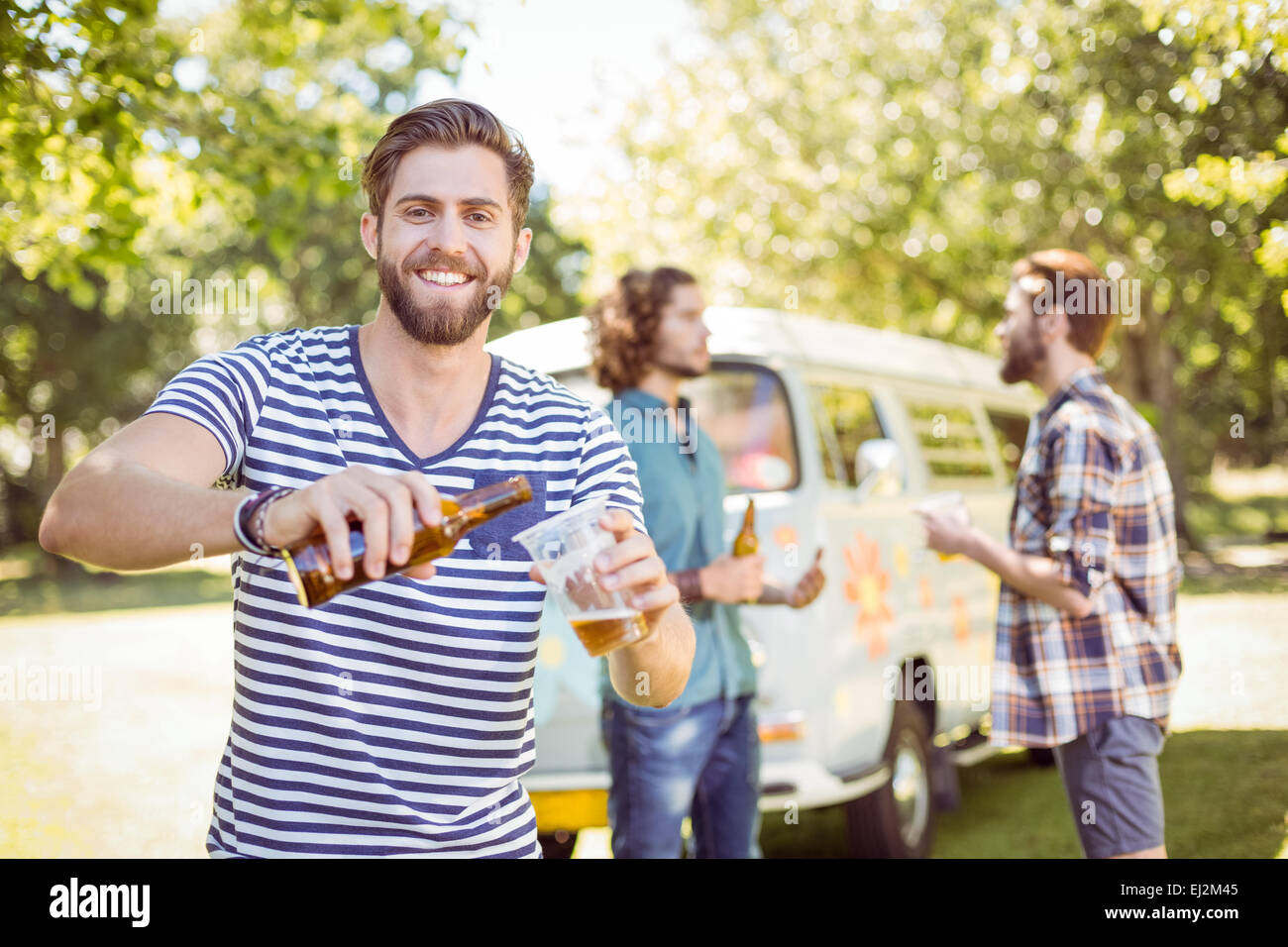 Male friends pouring beer hi-res stock photography and images - Alamy