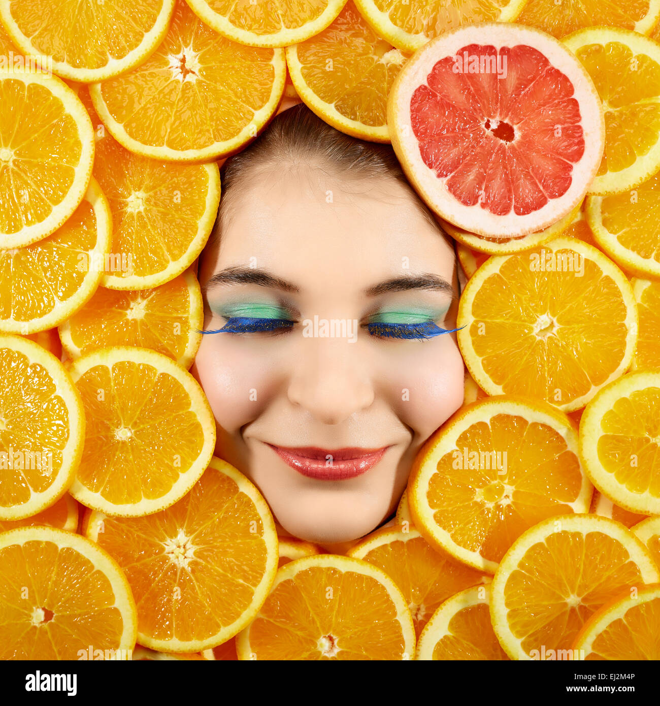woman with orange slice Stock Photo - Alamy