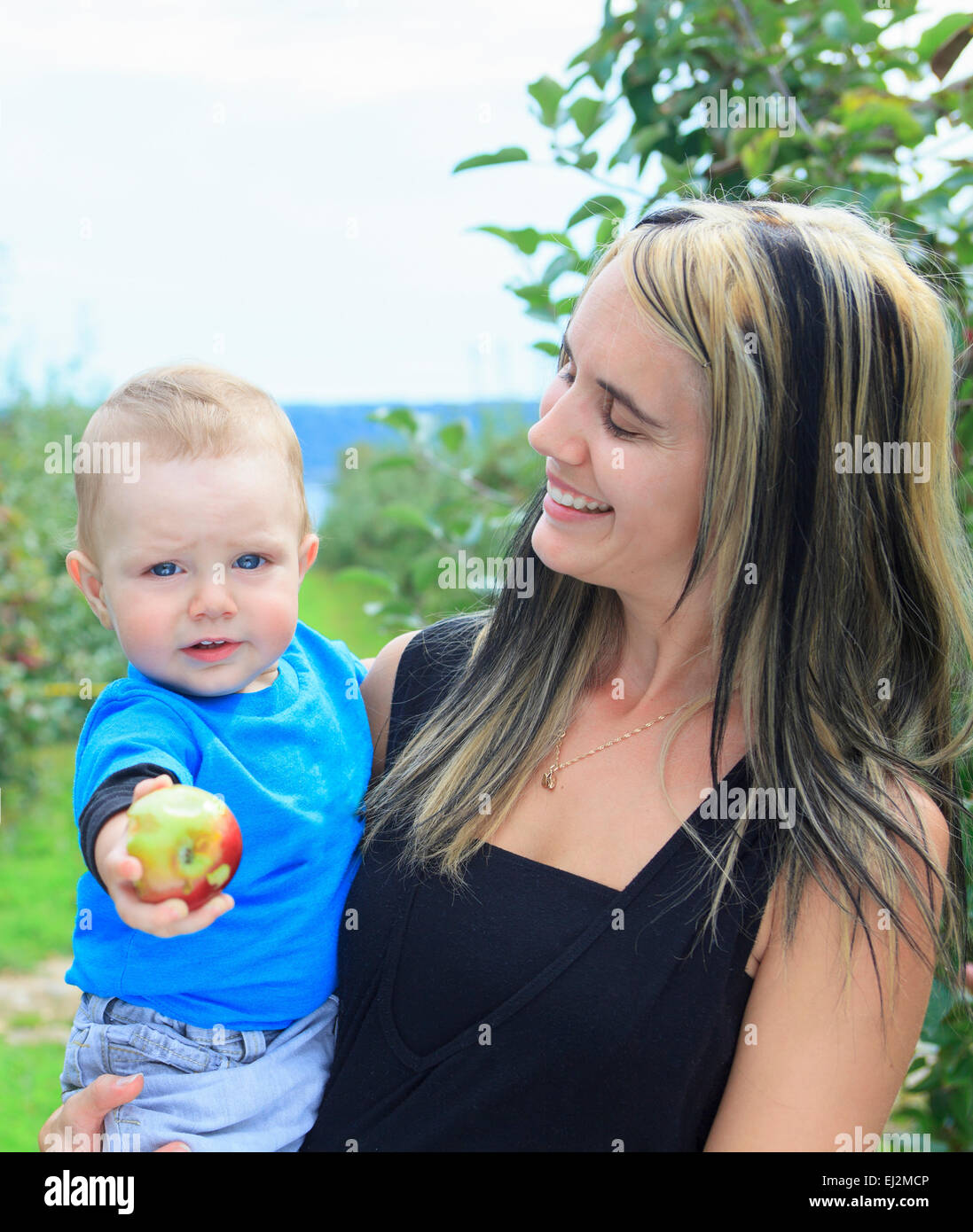 mother and her son with apple background Stock Photo - Alamy