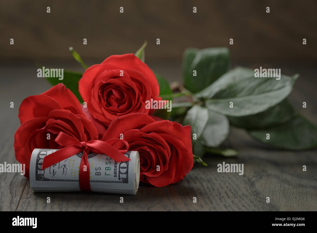 three red roses and bunch of dollars Stock Photo - Alamy
