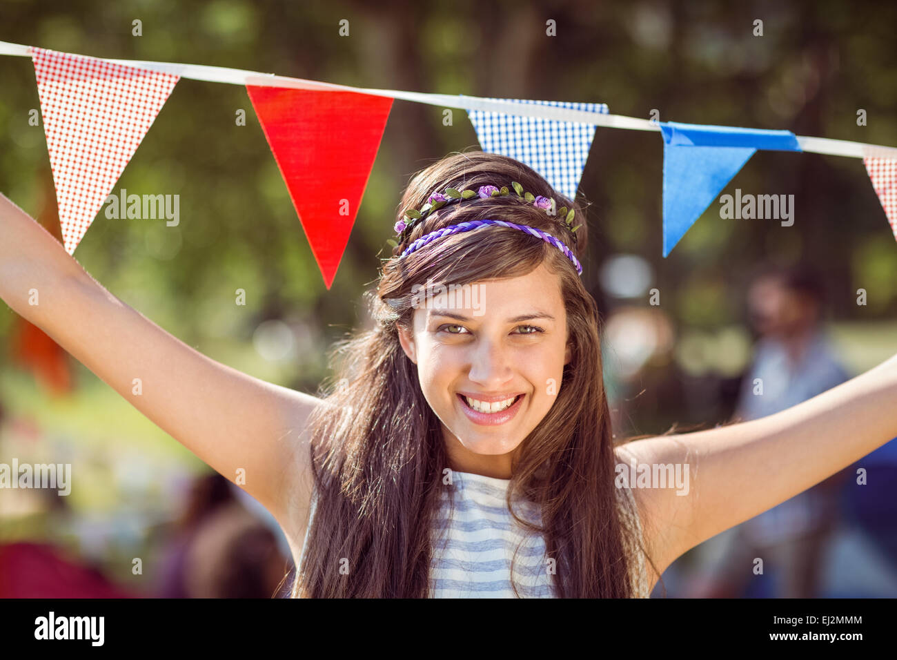 Pretty hipster posing for camera with flags Stock Photo - Alamy