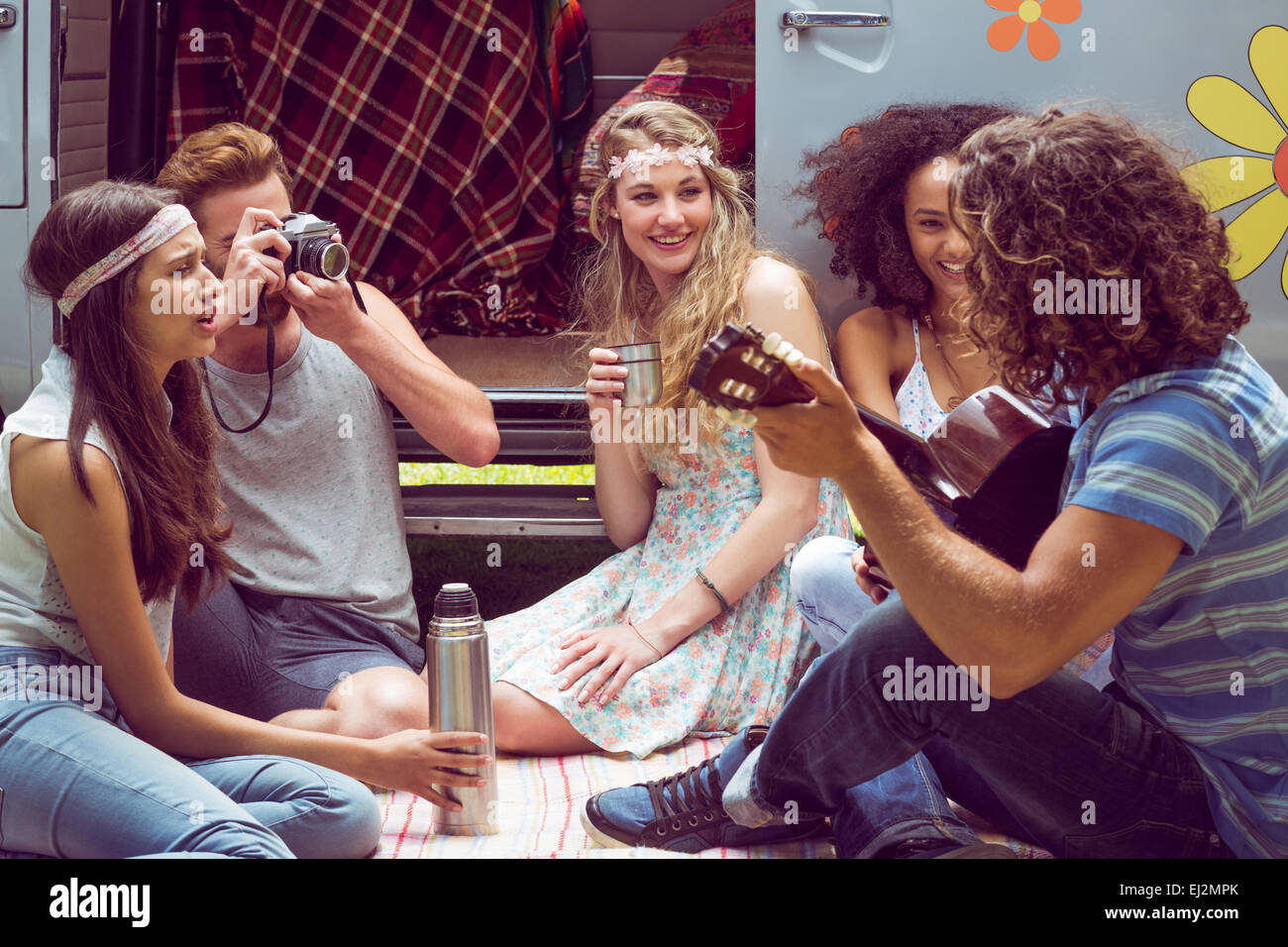 Hipster friends by camper van at festival Stock Photo - Alamy