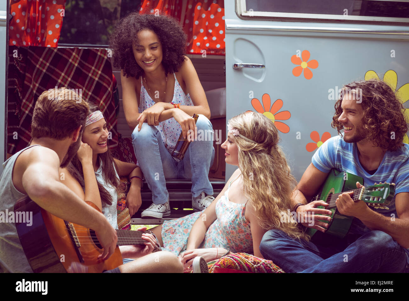 Hipster friends by camper van at festival Stock Photo - Alamy