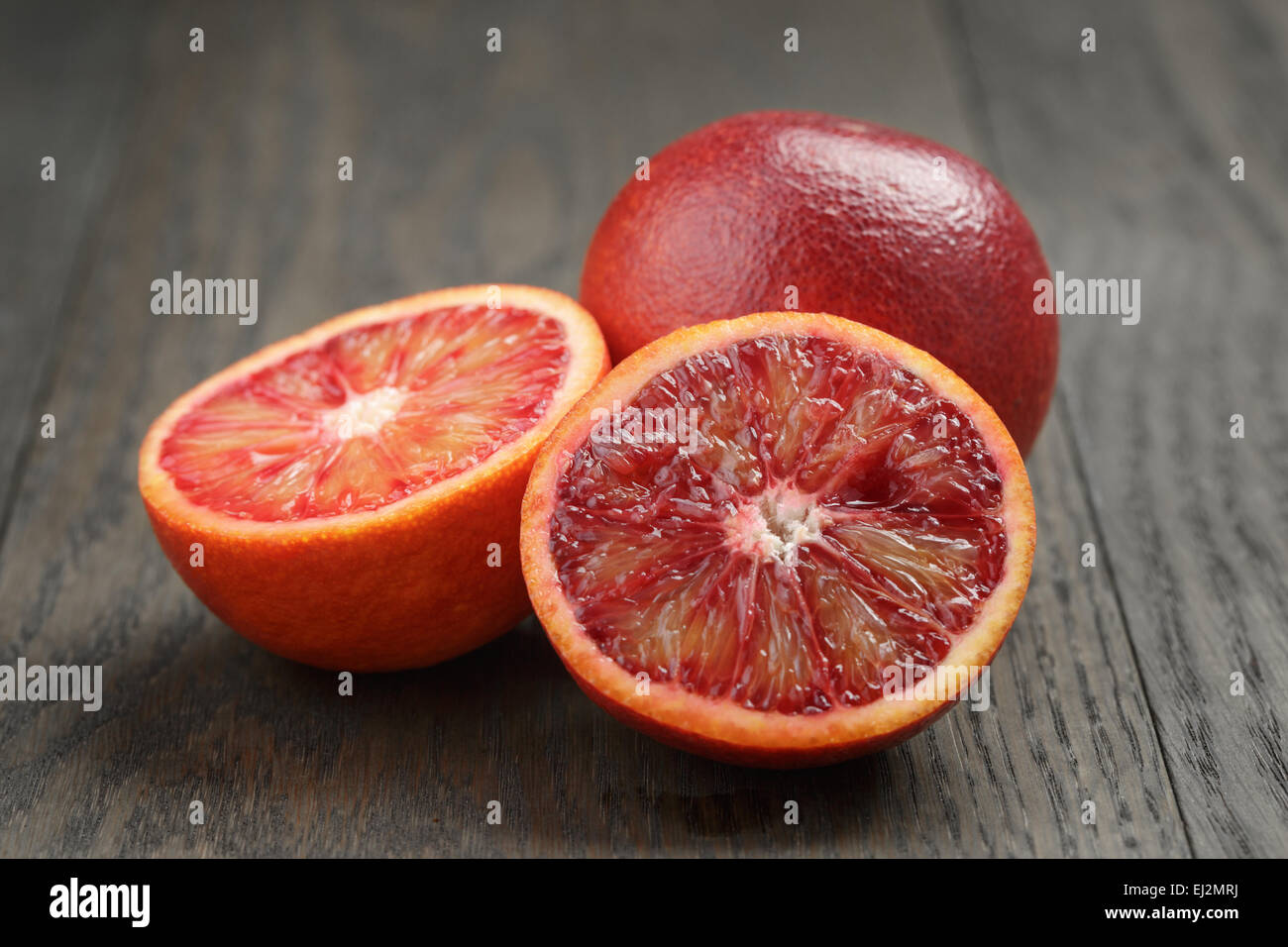 red sicilian oranges sliced on wooden table Stock Photo - Alamy