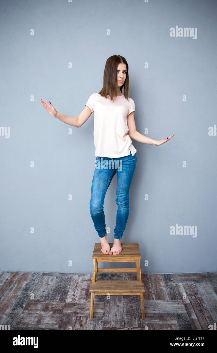 Young woman dancing on the chair Stock Photo - Alamy