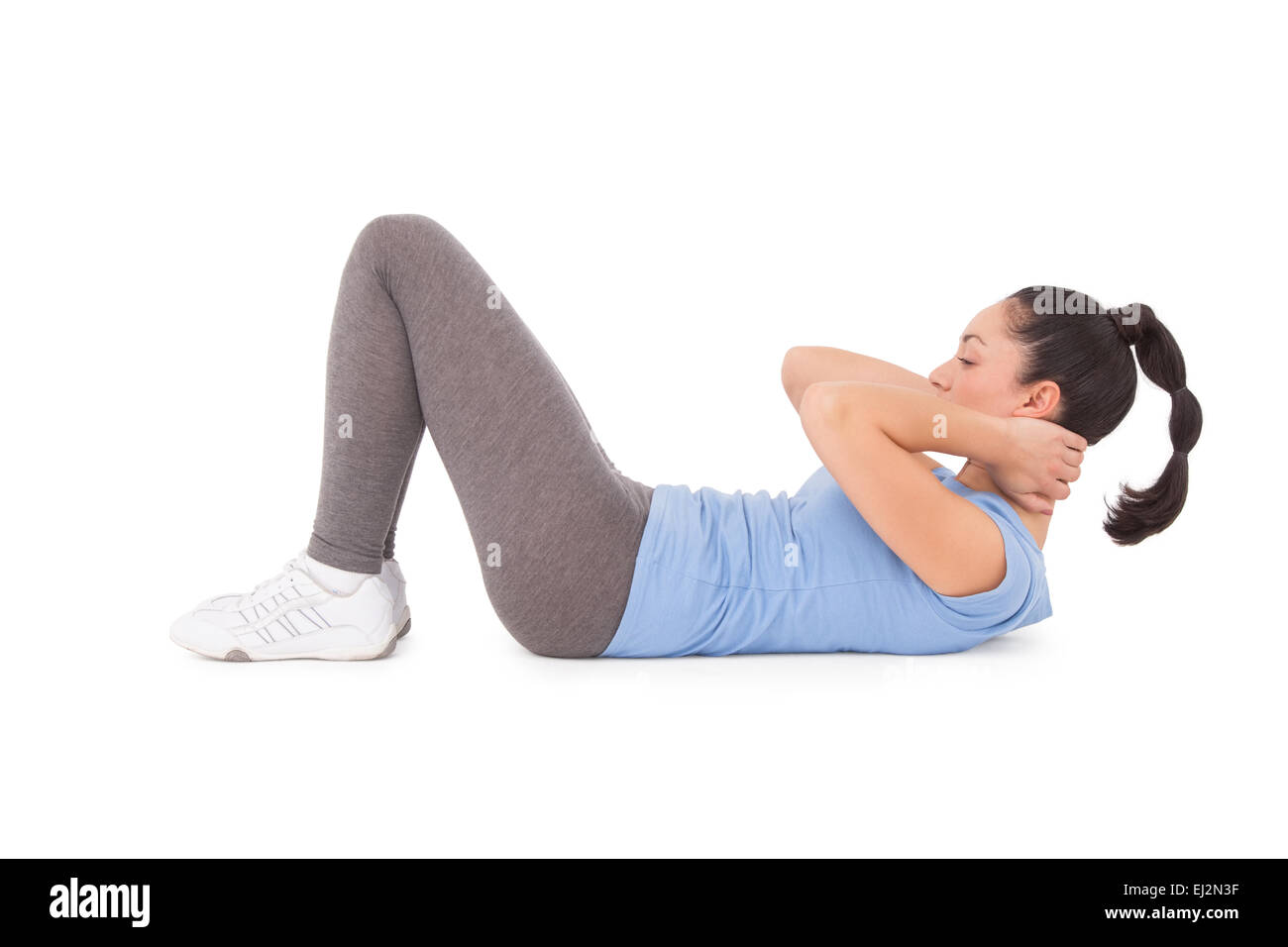 Fit brunette doing sit ups Stock Photo - Alamy