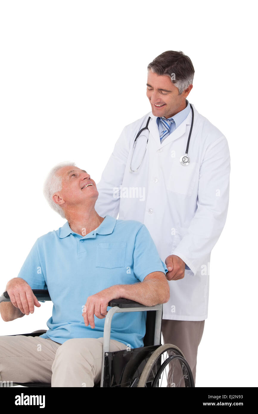 Doctor pushing senior patient in wheelchair Stock Photo - Alamy