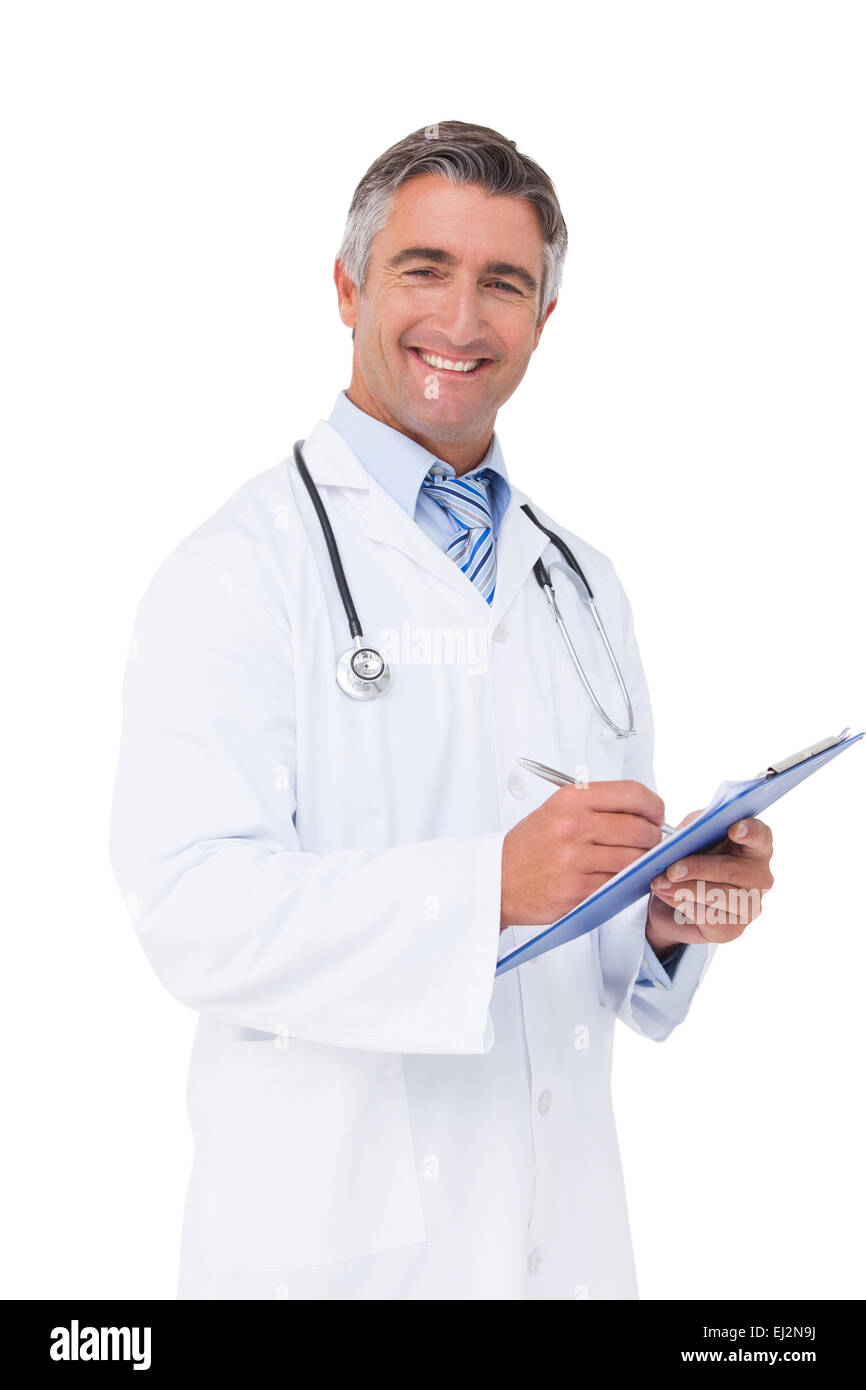 Happy doctor writing on clipboard Stock Photo - Alamy