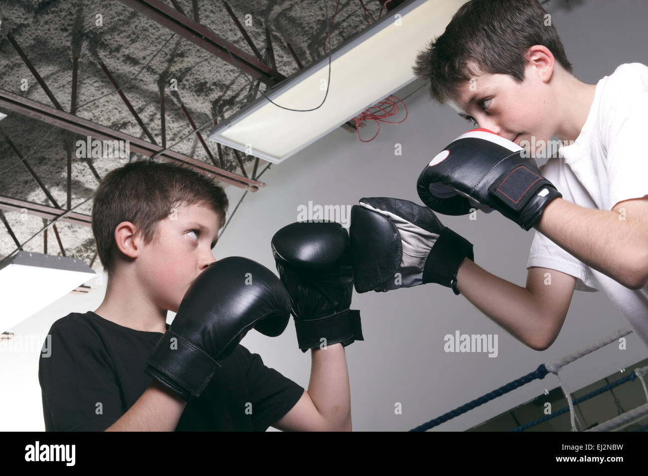 young boy with black boxing gloves fight with is brother Stock Photo ...